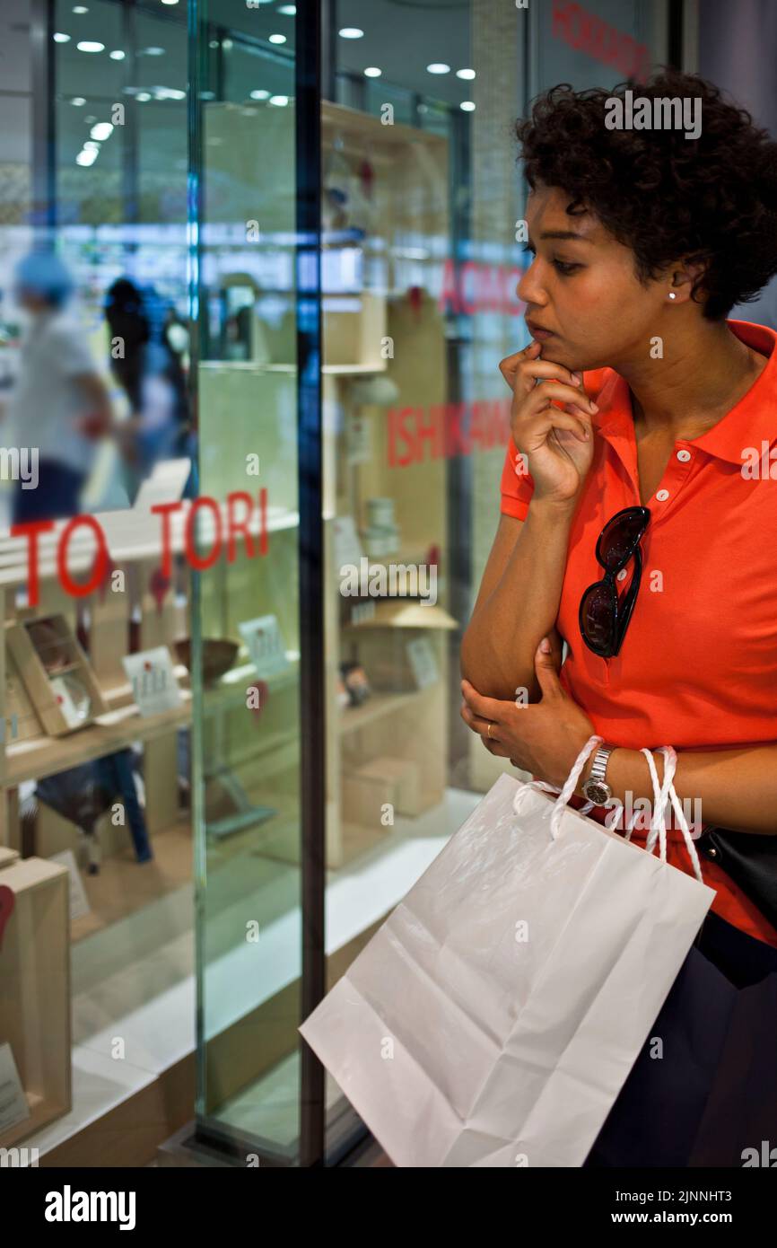 Young woman window shopping in Shibuya, Tokyo, Japan Stock Photo - Alamy