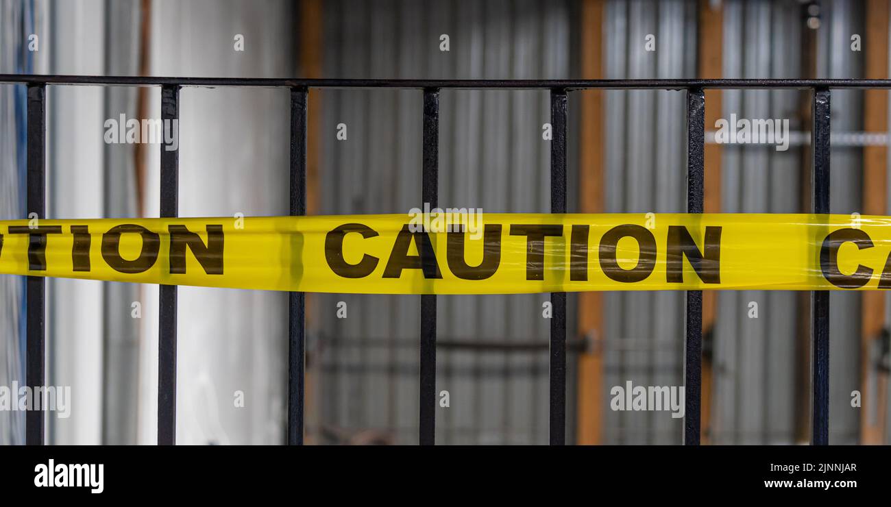 Yellow caution tape on stair metal handrails Stock Photo - Alamy
