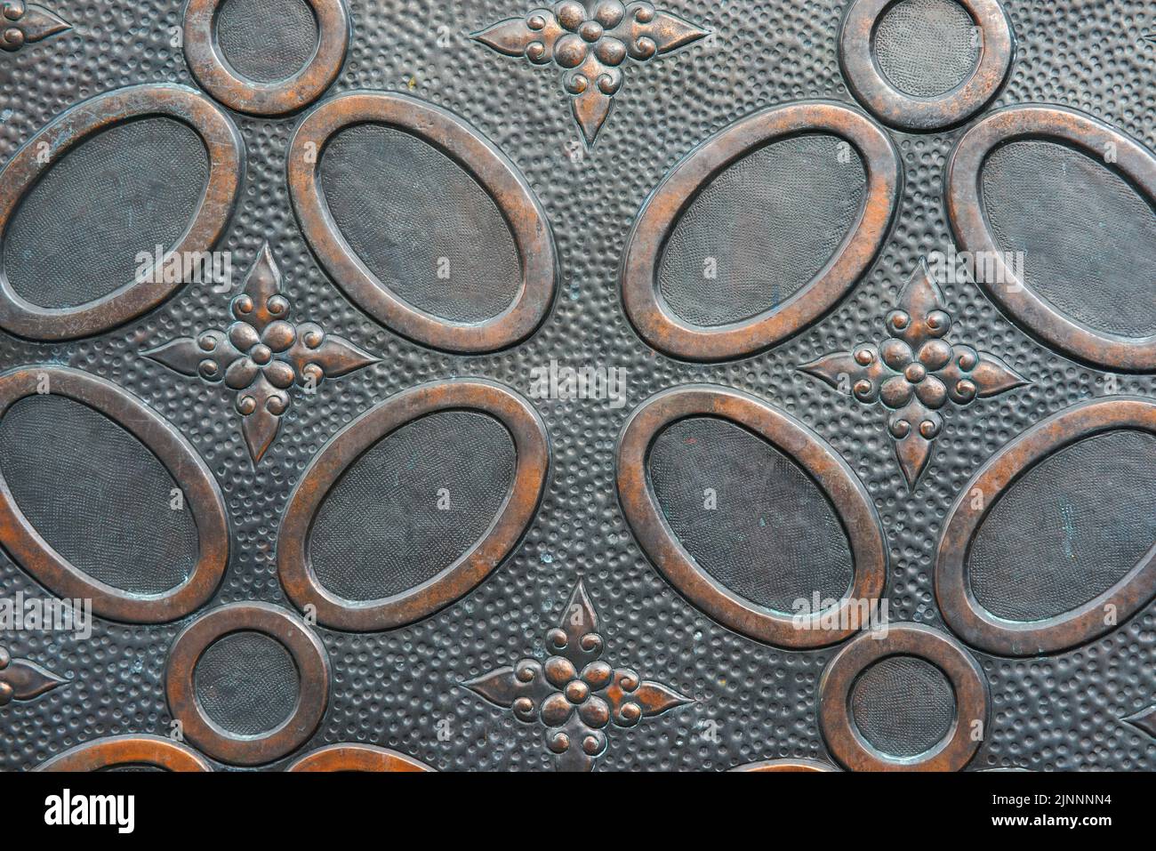 Traditional indonesian batik textured on steel. wall of steel is carved ...