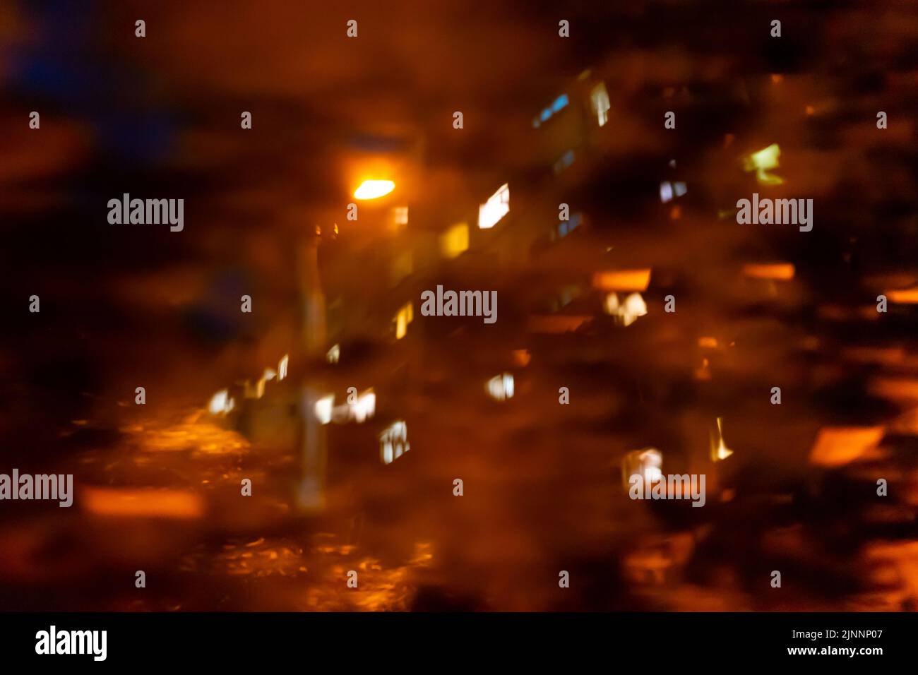 Light in the windows of the house at night. Abstract scary landscape ...