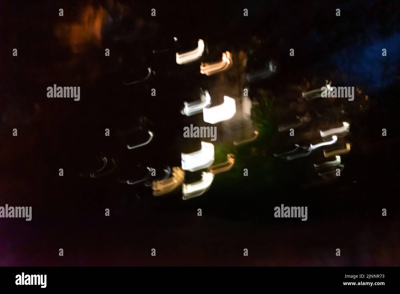 Close up shot of Several different colored lines moving in the dark ...