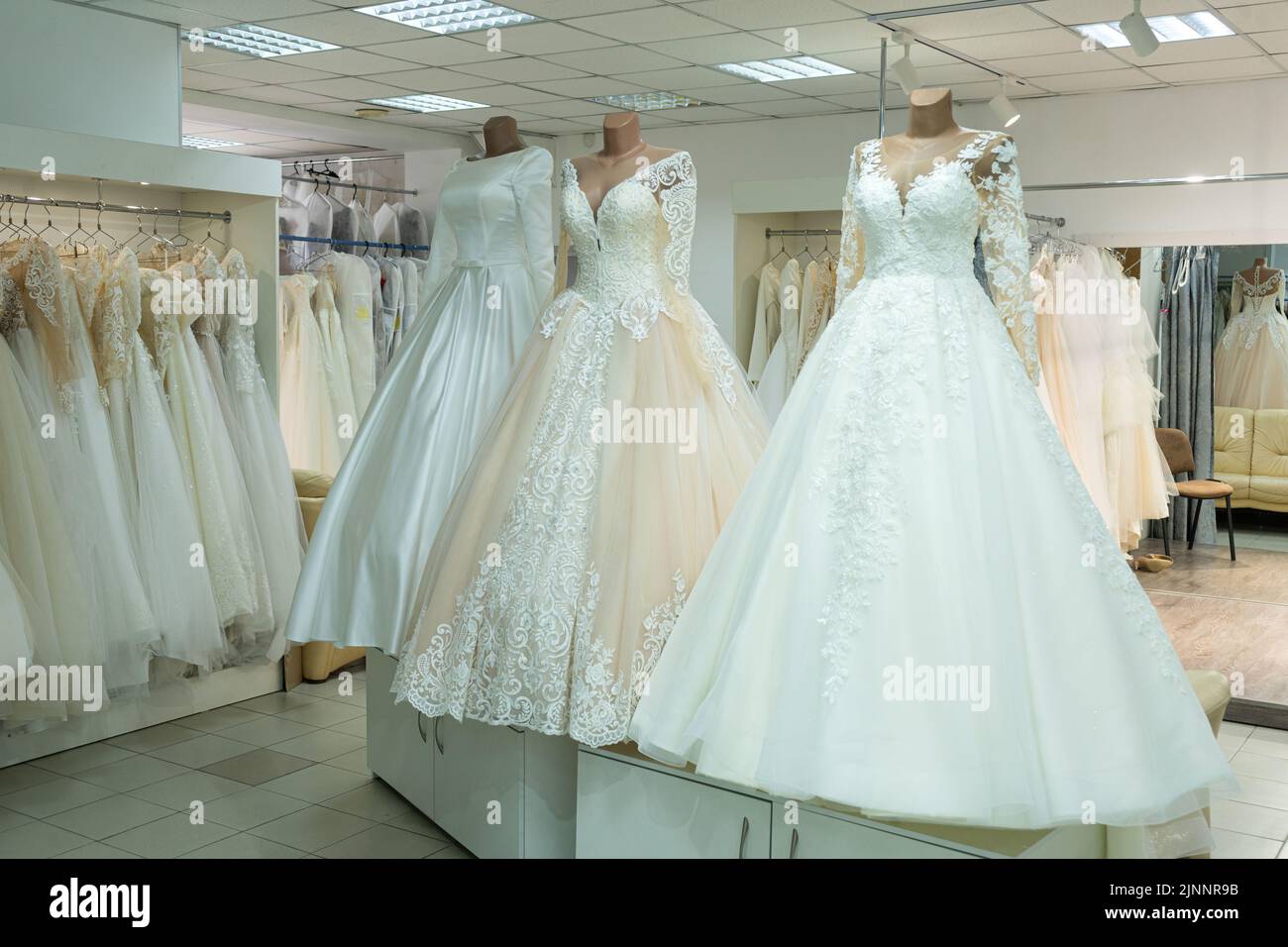 Three chic wedding dresses on mannequins. Three different models of ...