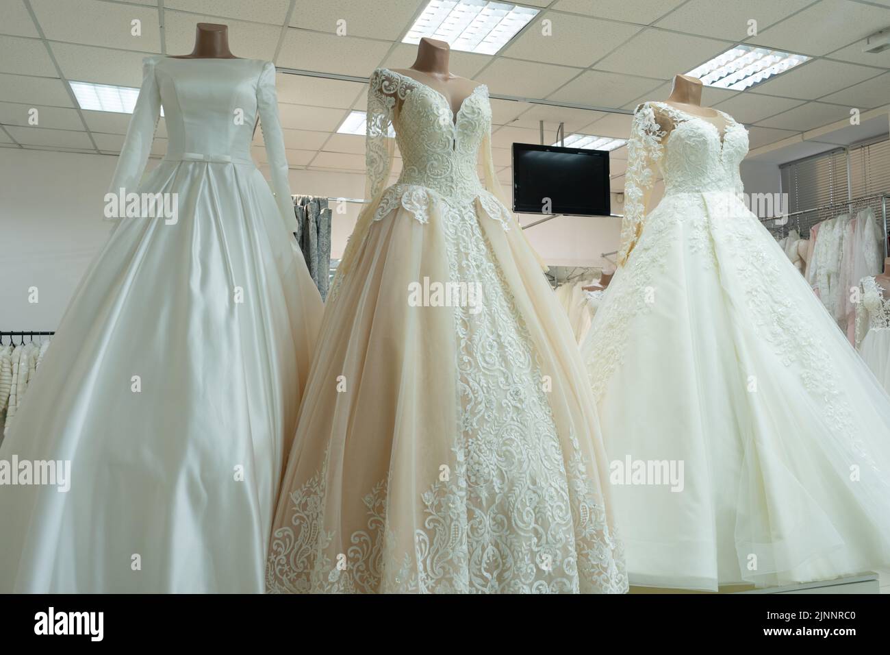 Three chic wedding dresses on mannequins. Three different models of ...