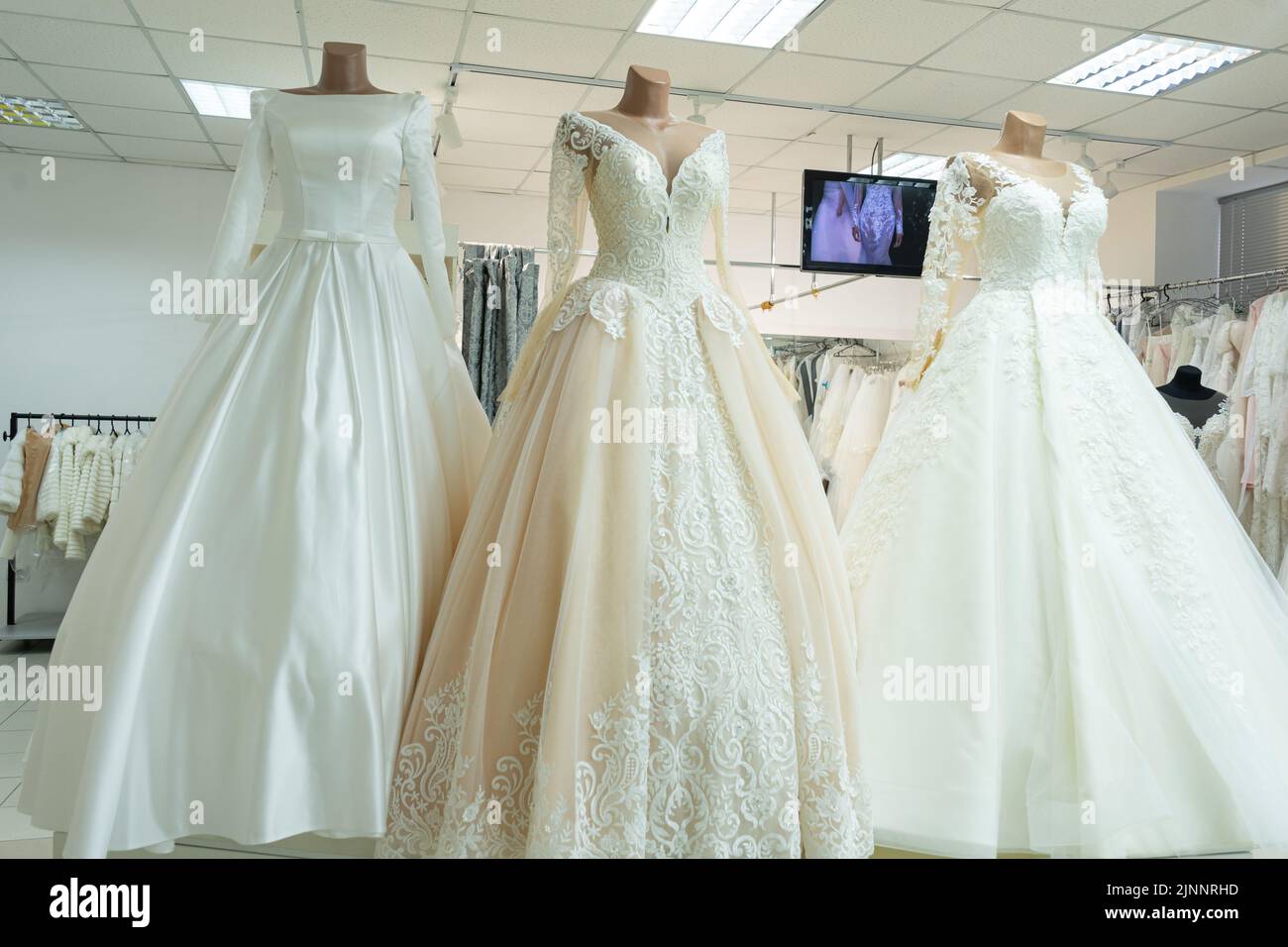 Three chic wedding dresses on mannequins. Three different models of ...