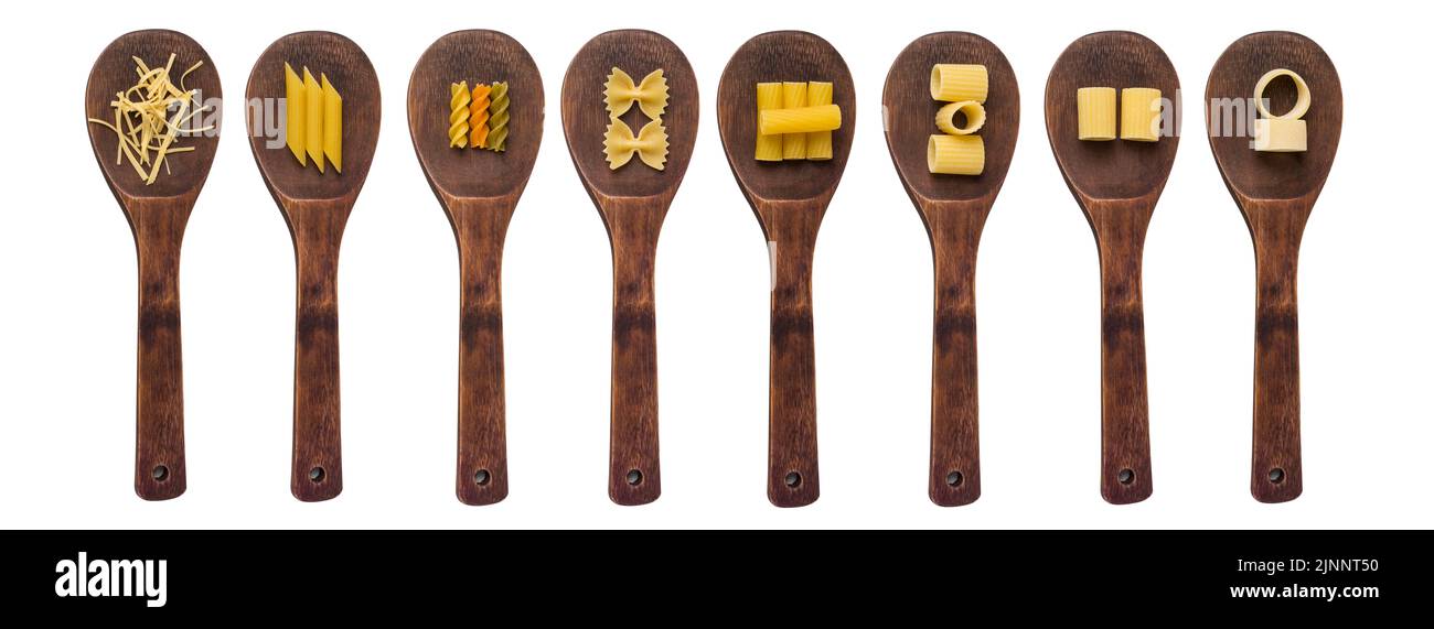 Wooden cooking spoons filled with various types dry pasta isolated on a ...