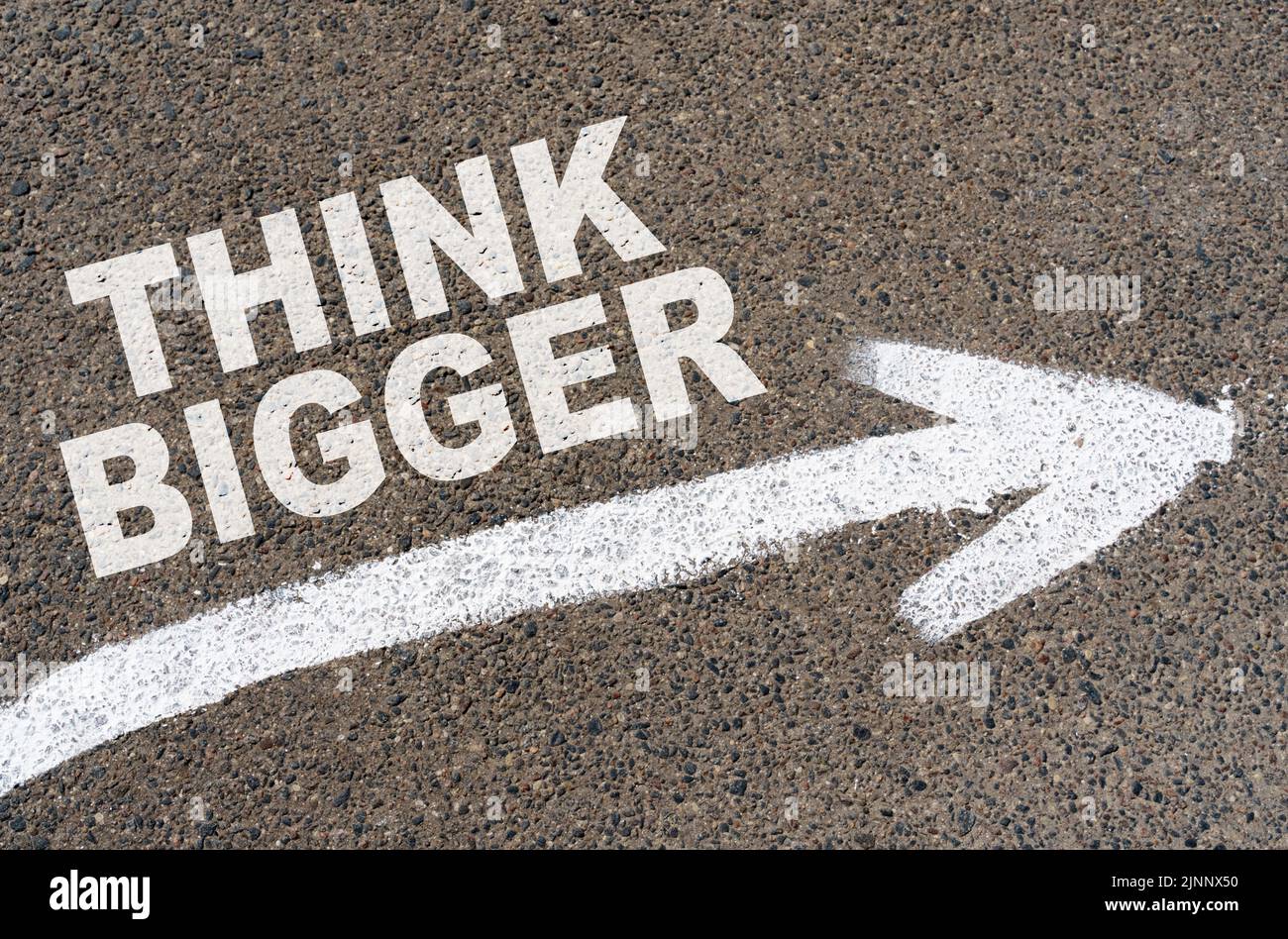 Business concept. On the asphalt road markings an arrow with the ...