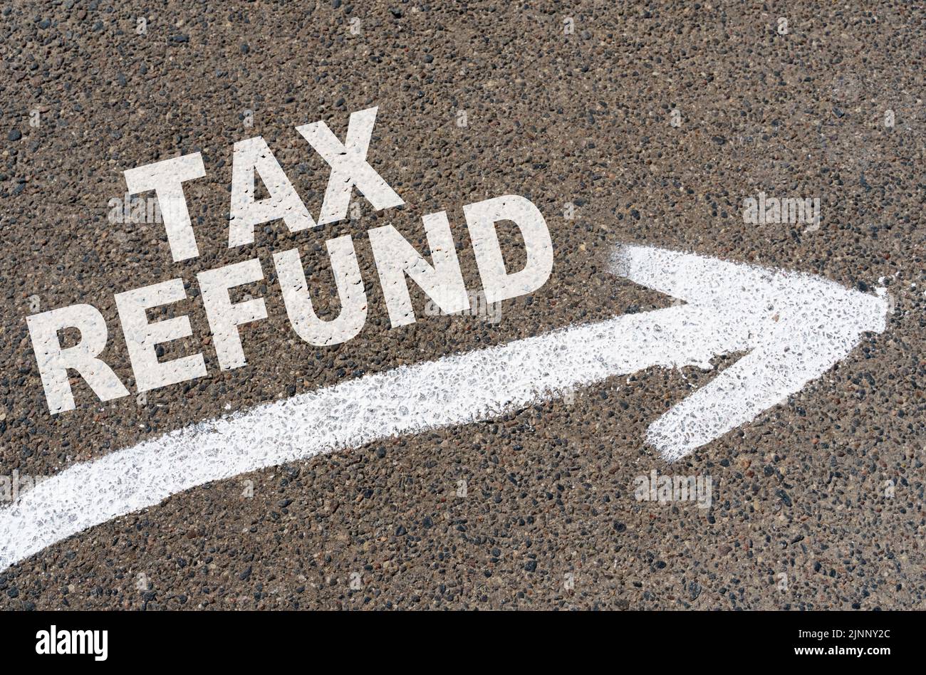 Business concept. On the asphalt road markings an arrow with the ...