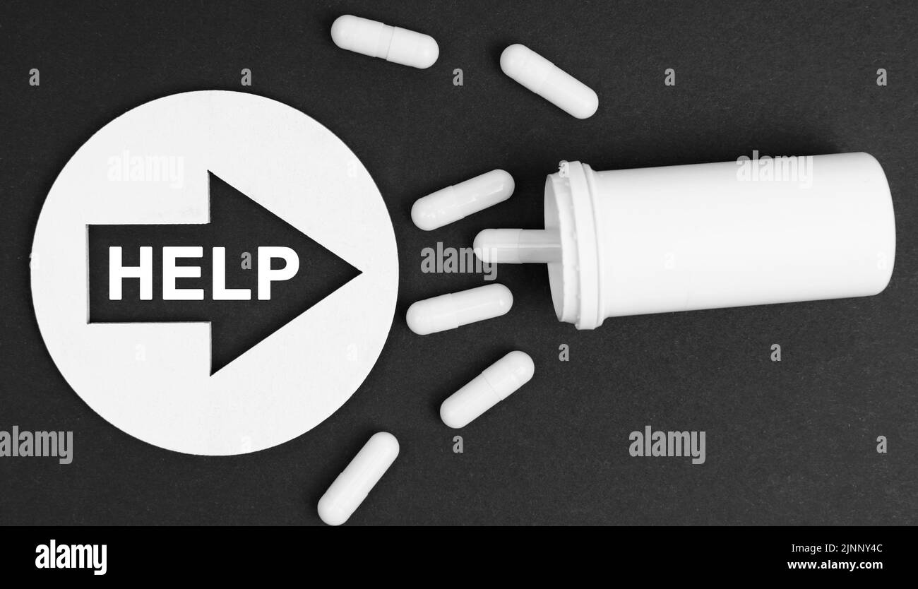 Medicine concept. Pills on a black background. They are indicated by a ...