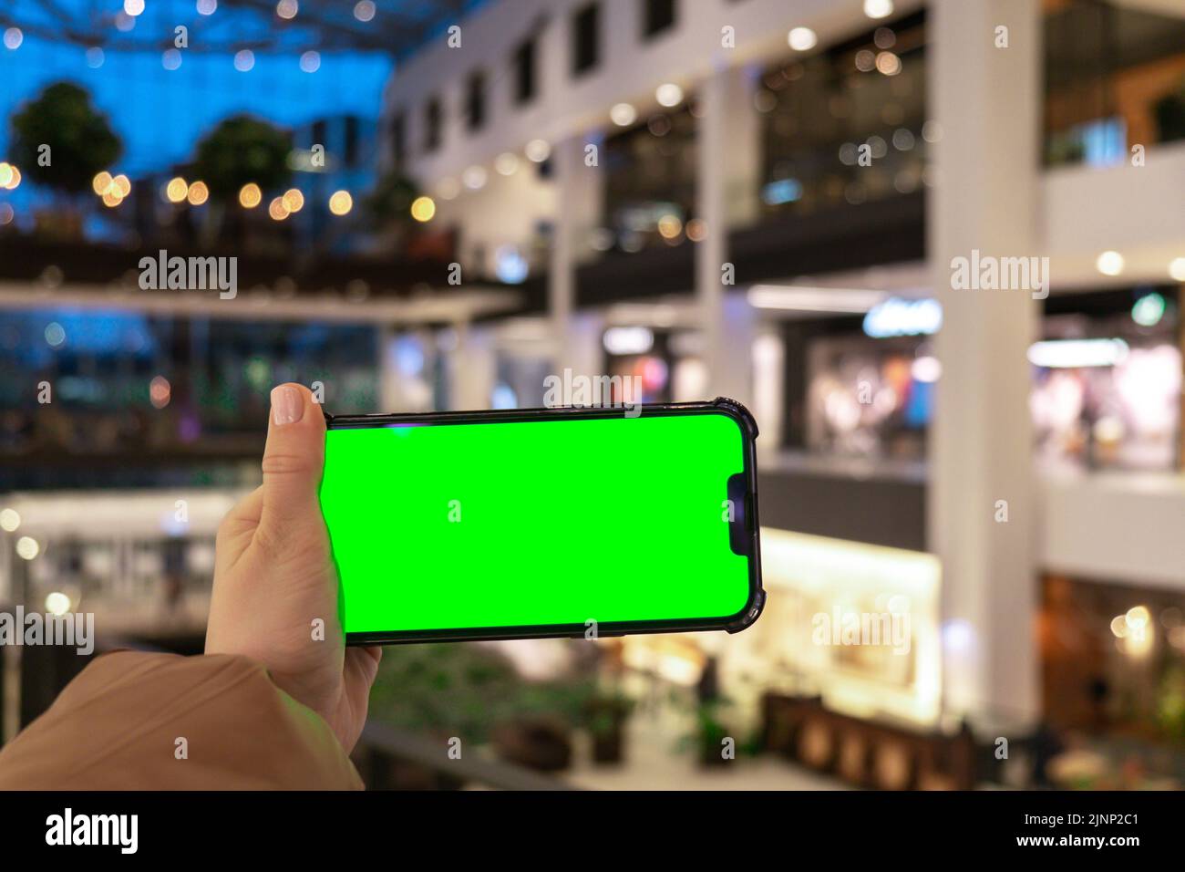 Chroma key. Close up of woman hand holds smart phone gorizontal with ...