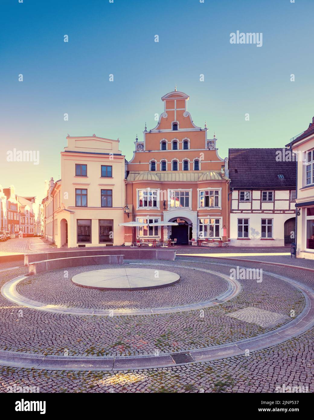 Old historic buildings Wismar, Germany. Empty circular square early ...