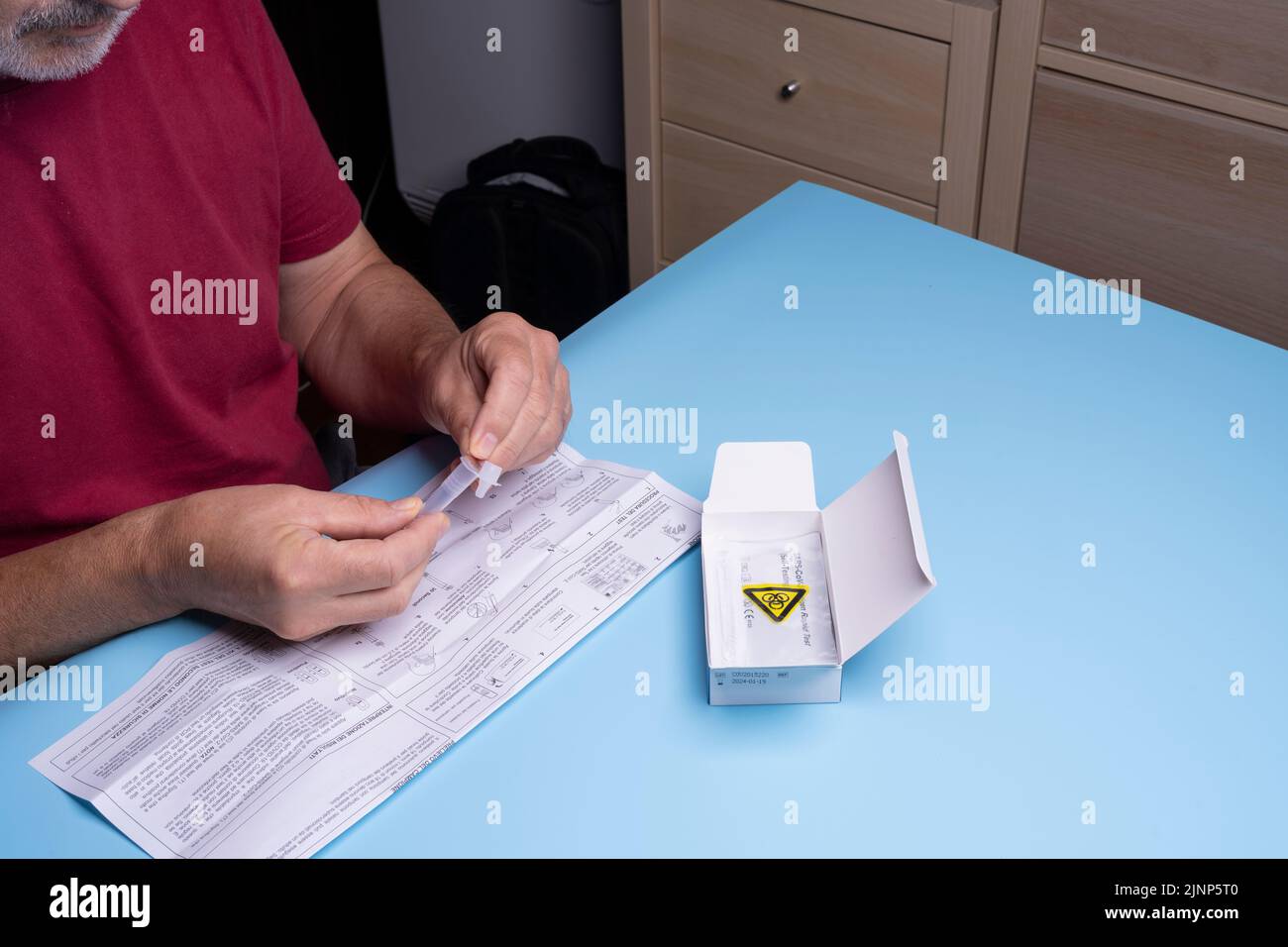 Step 2: opening the vial with the reagent liquid Stock Photo - Alamy
