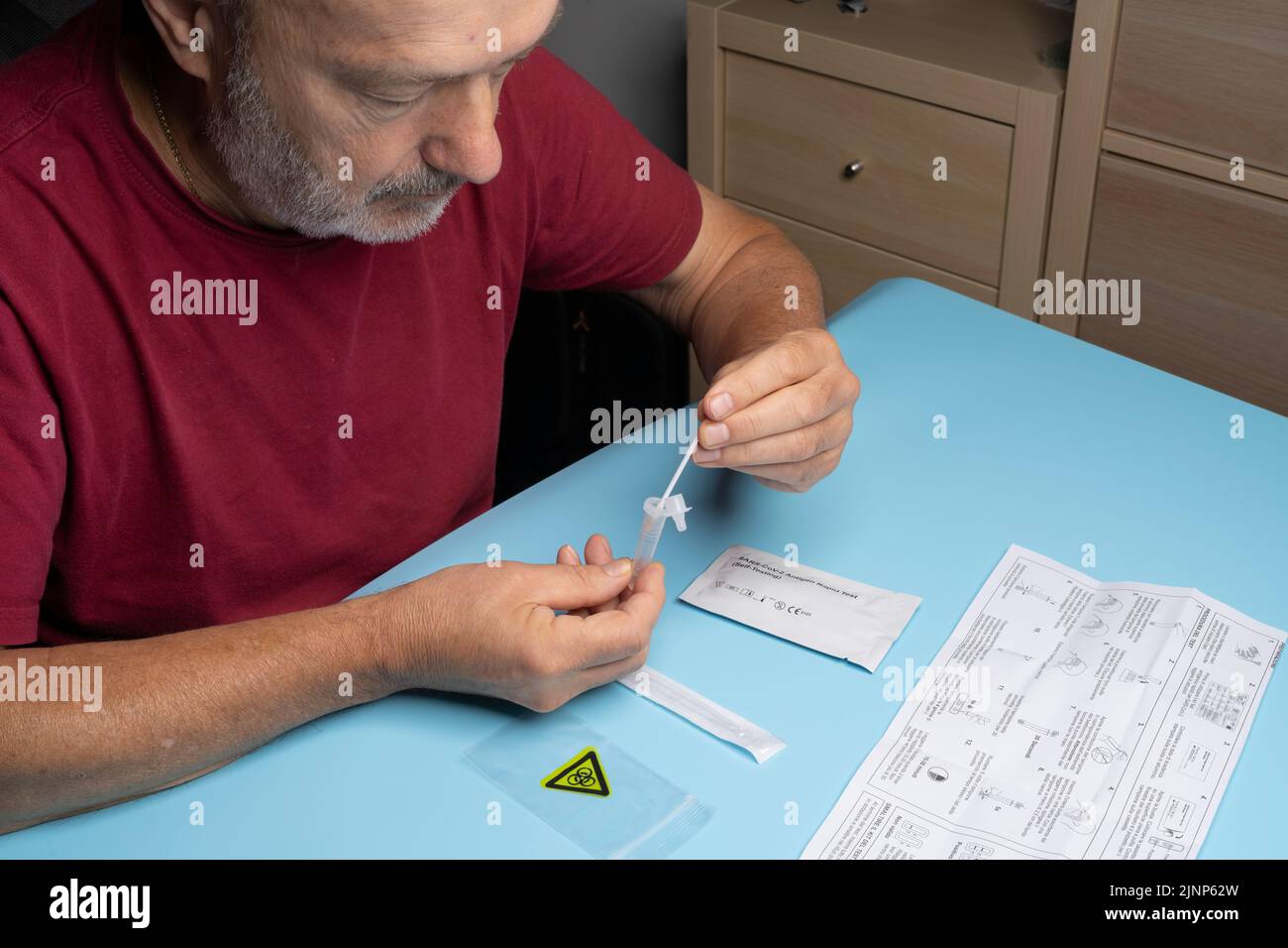 Step 5: inserting the swab into the reagent liquid Stock Photo - Alamy