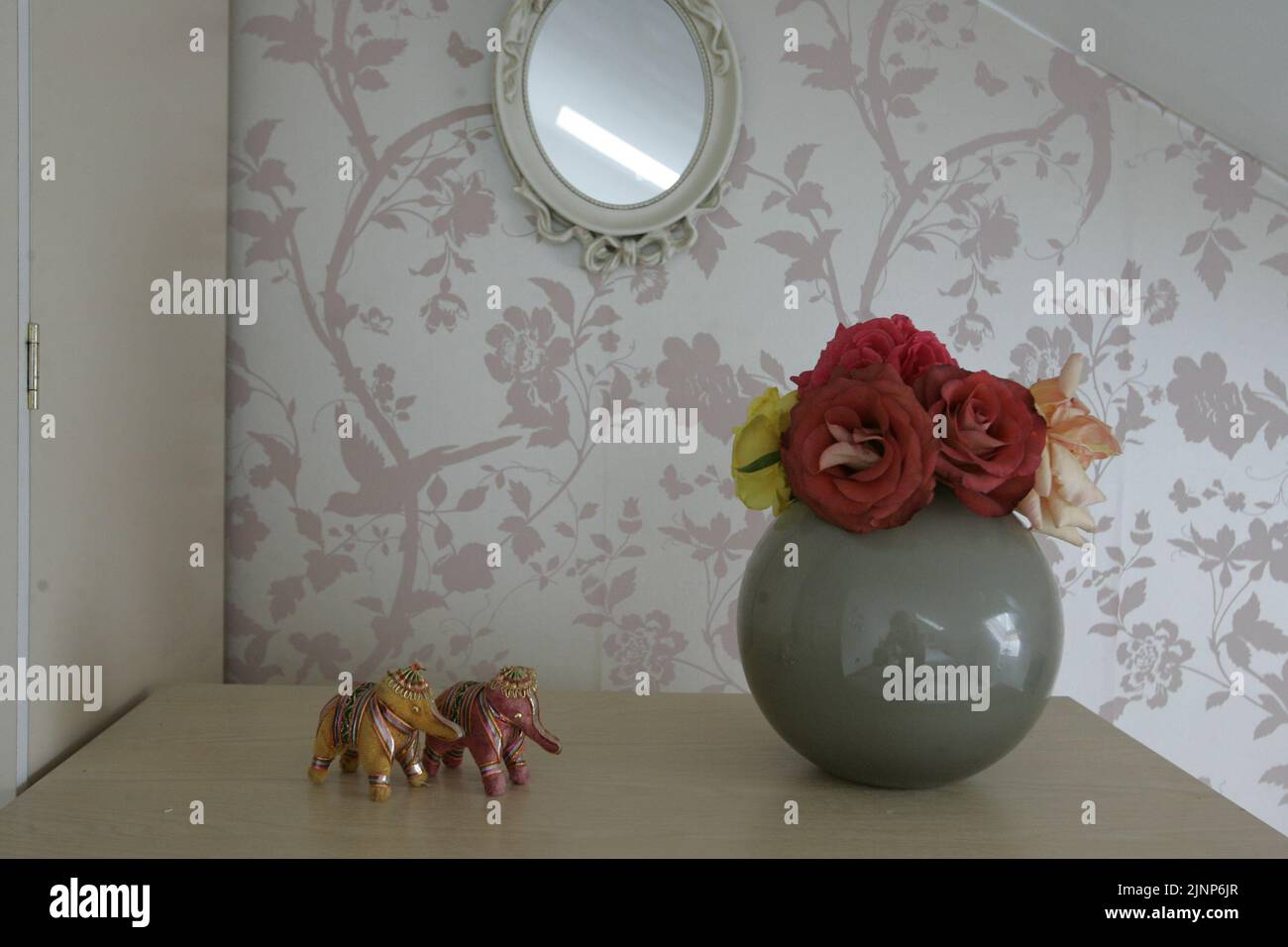flowers in a Vase and plant pot on dressing table with ornaments Stock ...