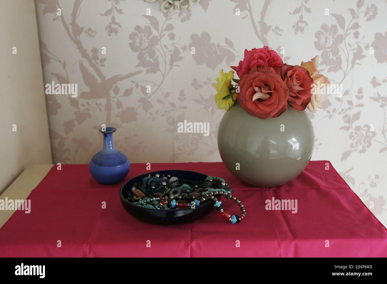 flowers in a Vase and plant pot on dressing table with ornaments Stock ...