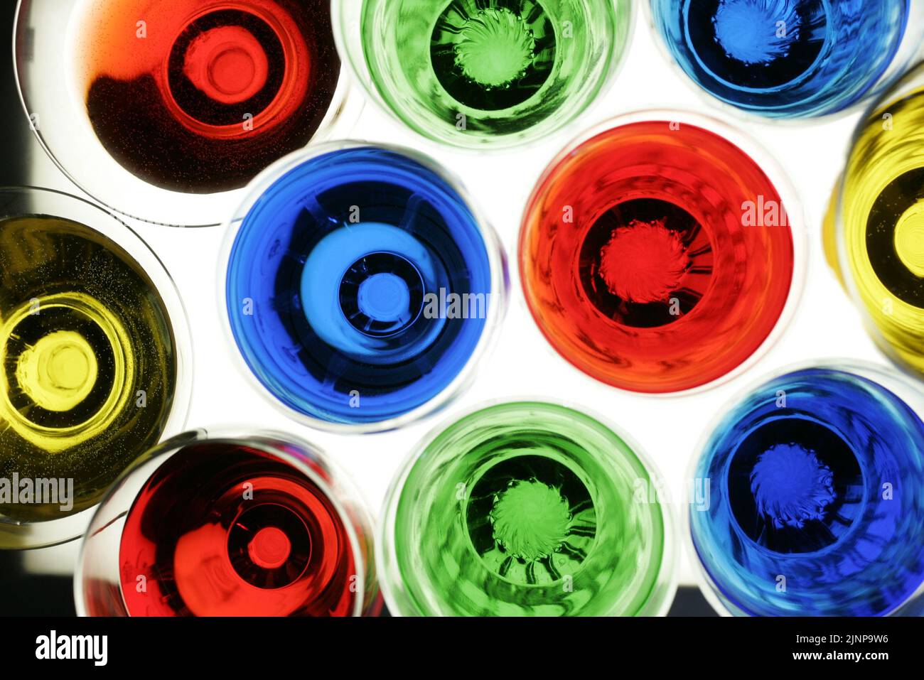 Wine glass with different coloured liquids in Stock Photo - Alamy
