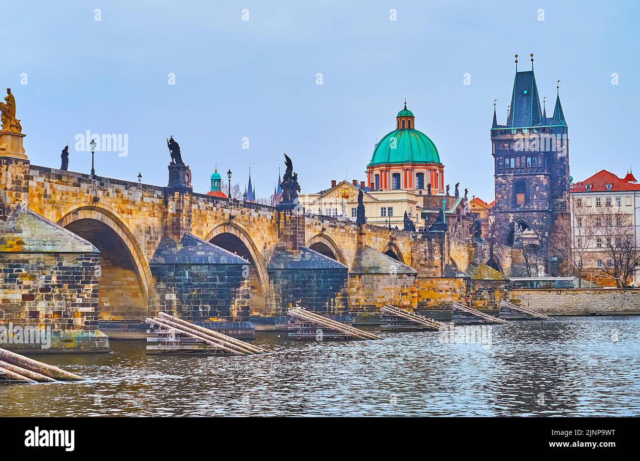 The medieval Gothic Charles Bridge with stone statues, arches and Old ...