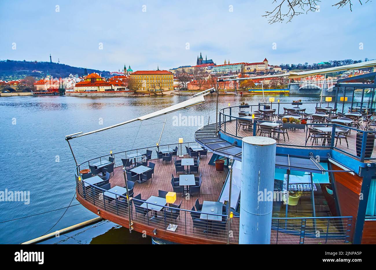 The upper and lower terraces of the boat-restaurant, moored at the bank ...