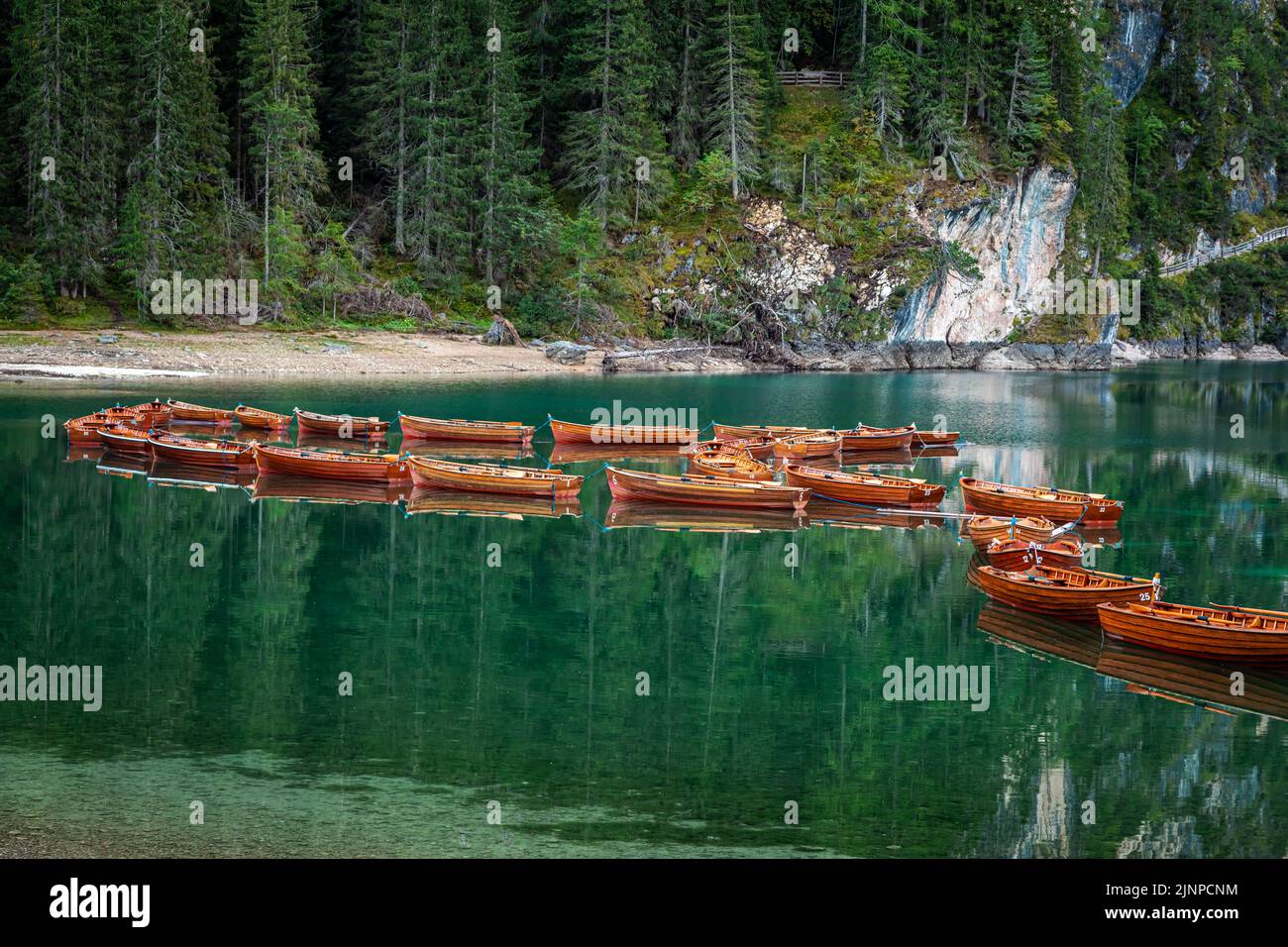 Wooden boats on mountain lake Lago di Braies in Italy, Dolomites Stock ...