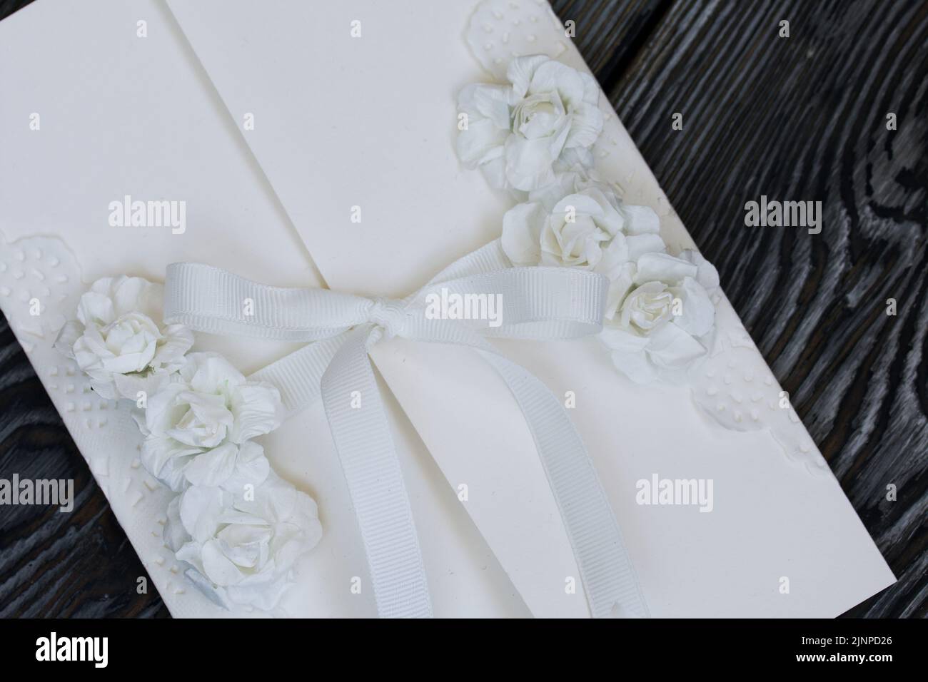 Greeting card handmade. Decorated with paper flowers and ribbons. Lies ...