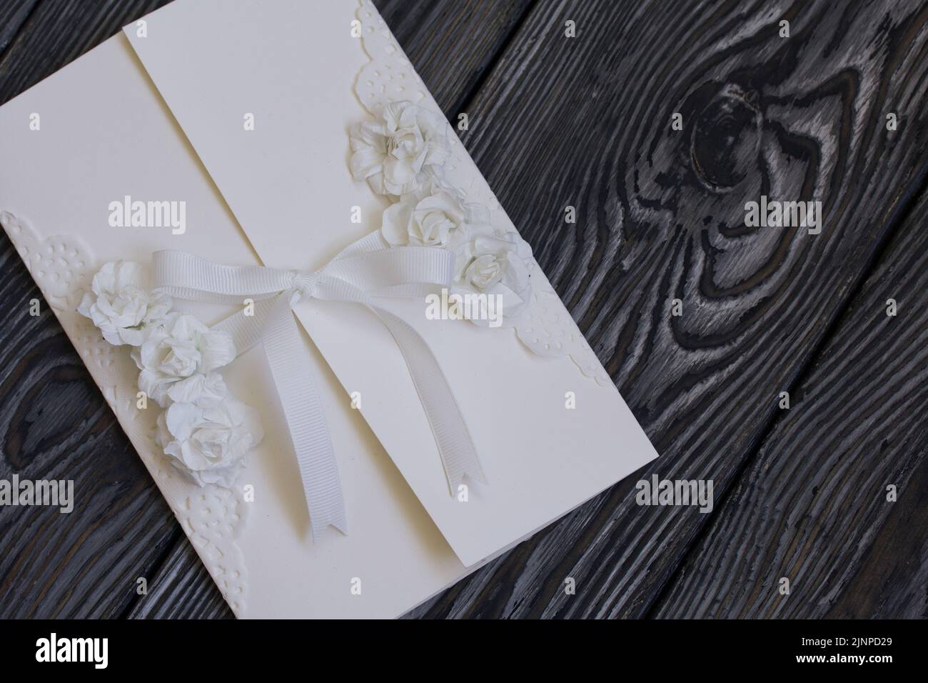 Greeting card handmade. Decorated with paper flowers and ribbons. Lies ...