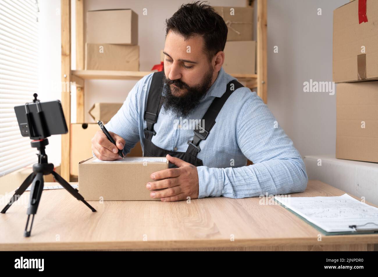 Start up. Indian man have new order from customer using mobile phone ...