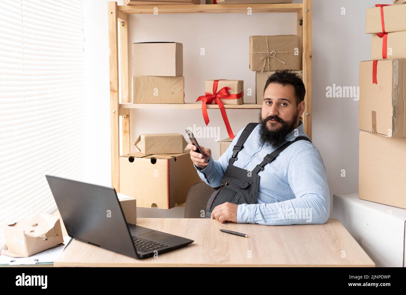 Indian male small business owner using mobile app on smartphone ...