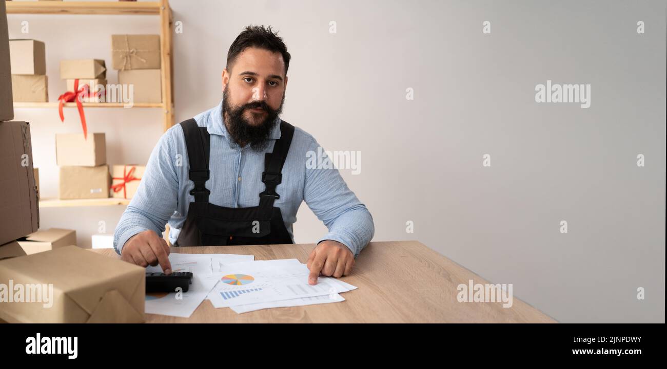 Young entrepreneur using calculator hi-res stock photography and images ...