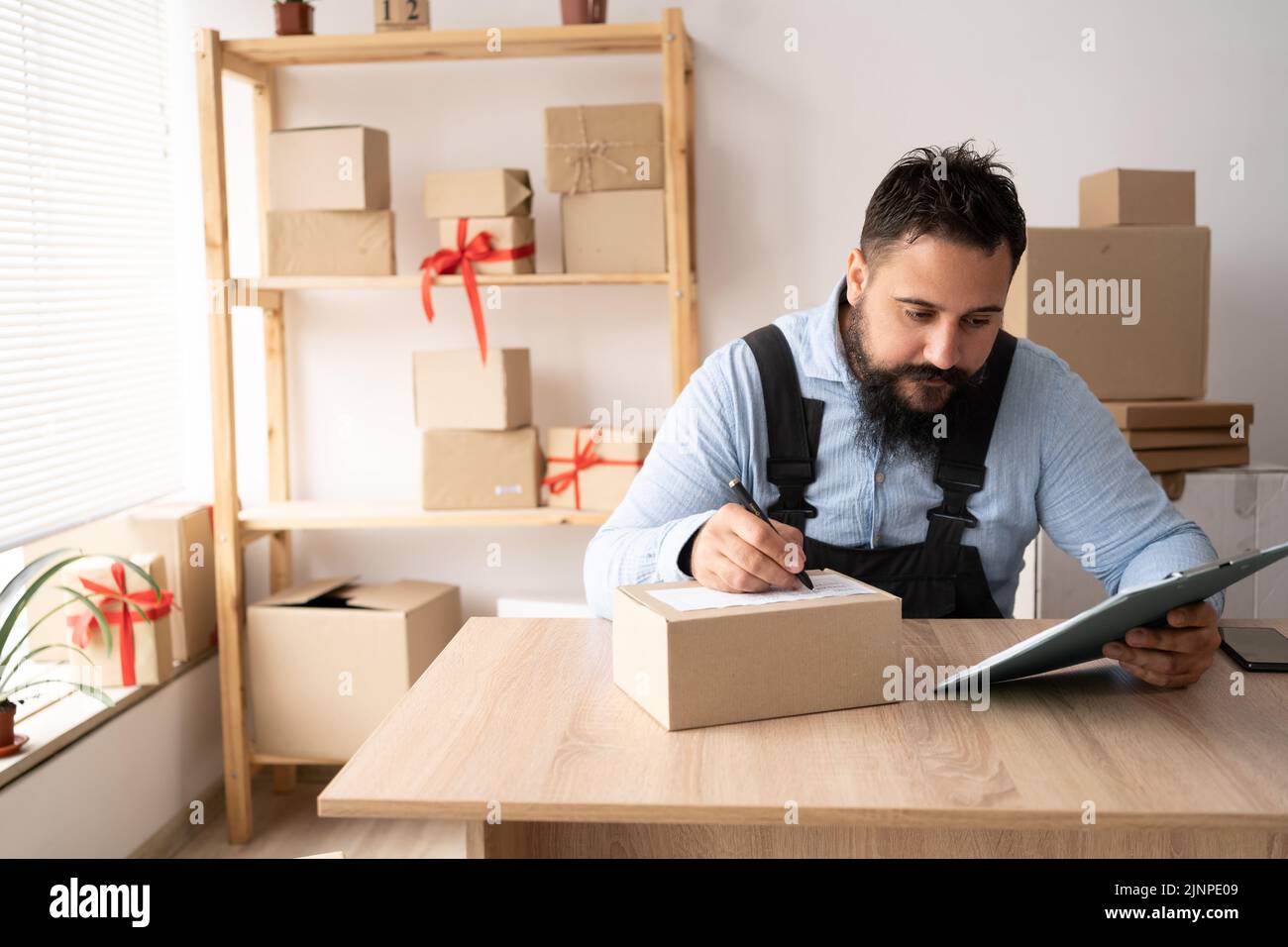 Start up entrepreneur of indian millennial man with box for packaging ...