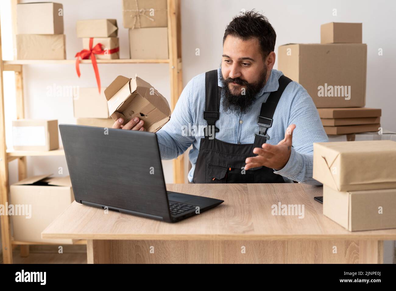 Evil bearded male business owner sitting at table and calling while ...