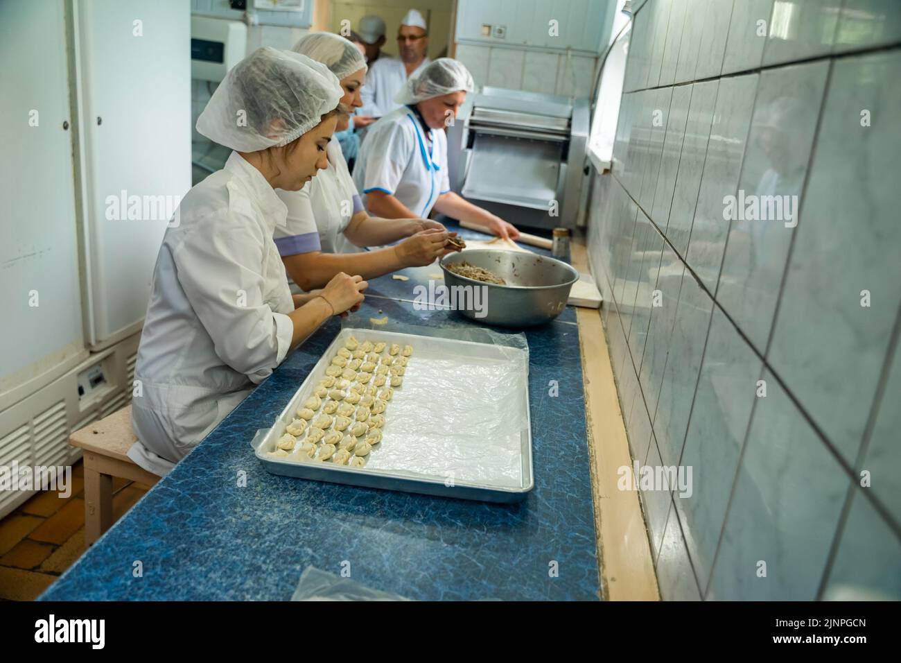 Tatarastan, Russia. 2022, 16 July. Women making Pelmeni or dumplings in ...
