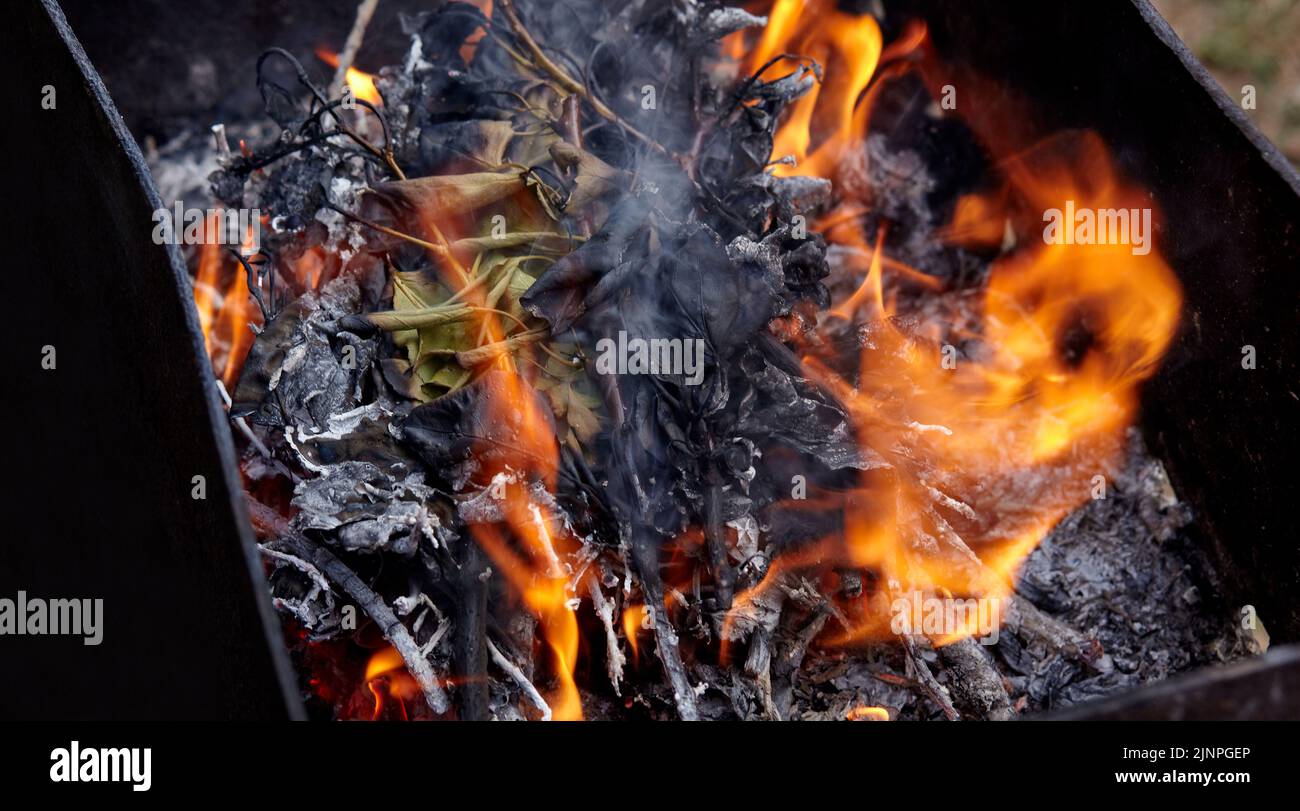 Burning red hot sparks fly from fire. Barbecue gril with glowing and ...