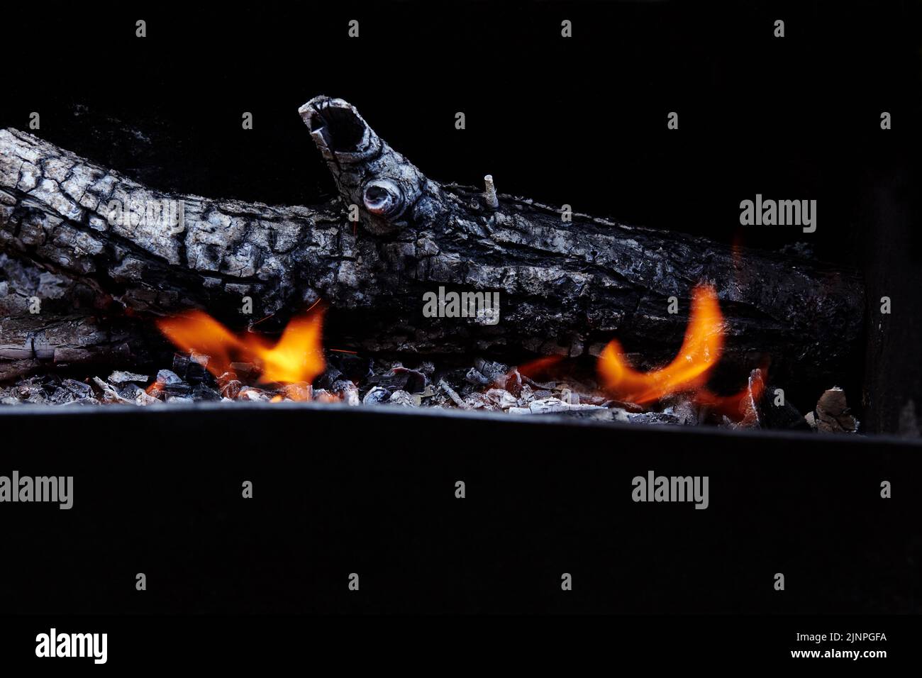 Burning red hot sparks fly from fire. Barbecue gril with glowing and ...