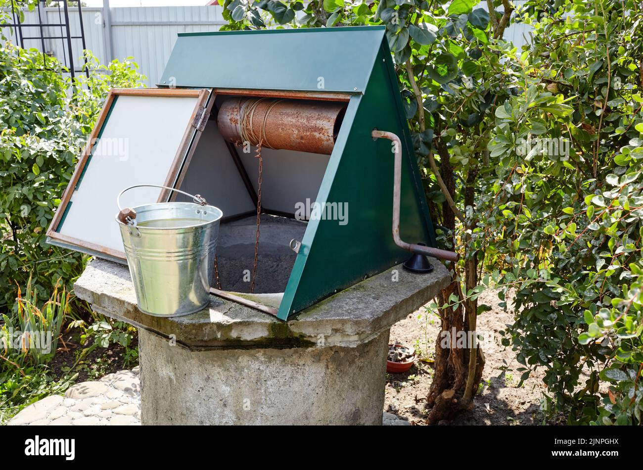 Old stone well with bucket hi-res stock photography and images - Alamy