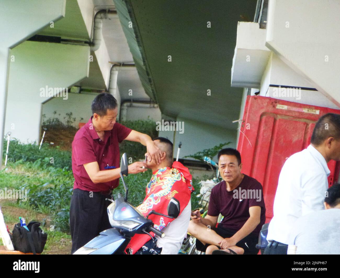 Shenzhen, China: roadside barber stalls charge cheap to attract people ...