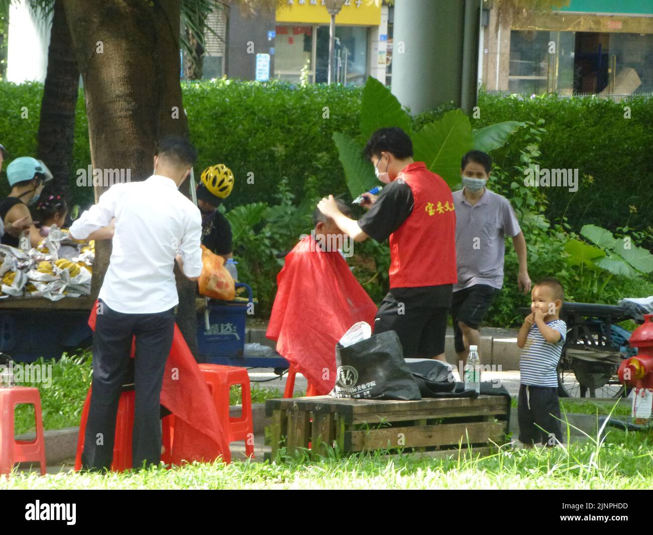Shenzhen, China: roadside barber stalls charge cheap to attract people ...