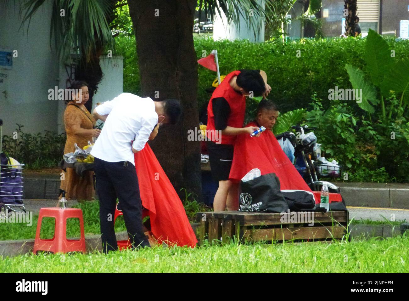 Shenzhen, China: roadside barber stalls charge cheap to attract people ...