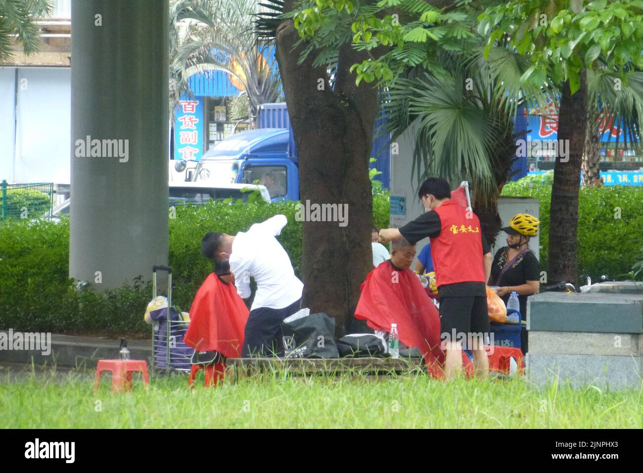 Shenzhen, China: roadside barber stalls charge cheap to attract people ...