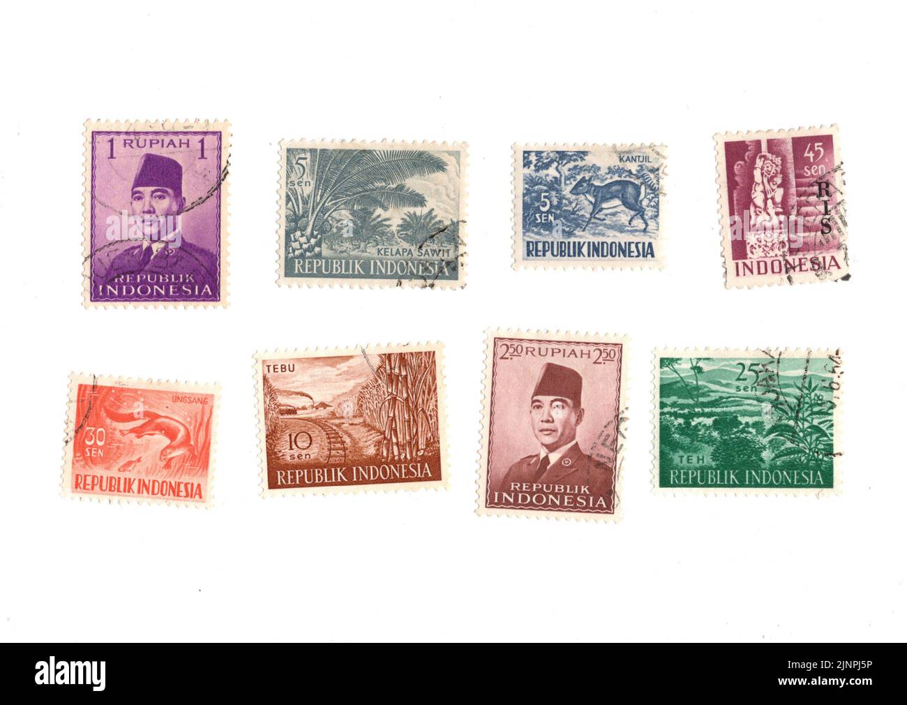 A selection of old postage stamps from Indonesia on a white background ...