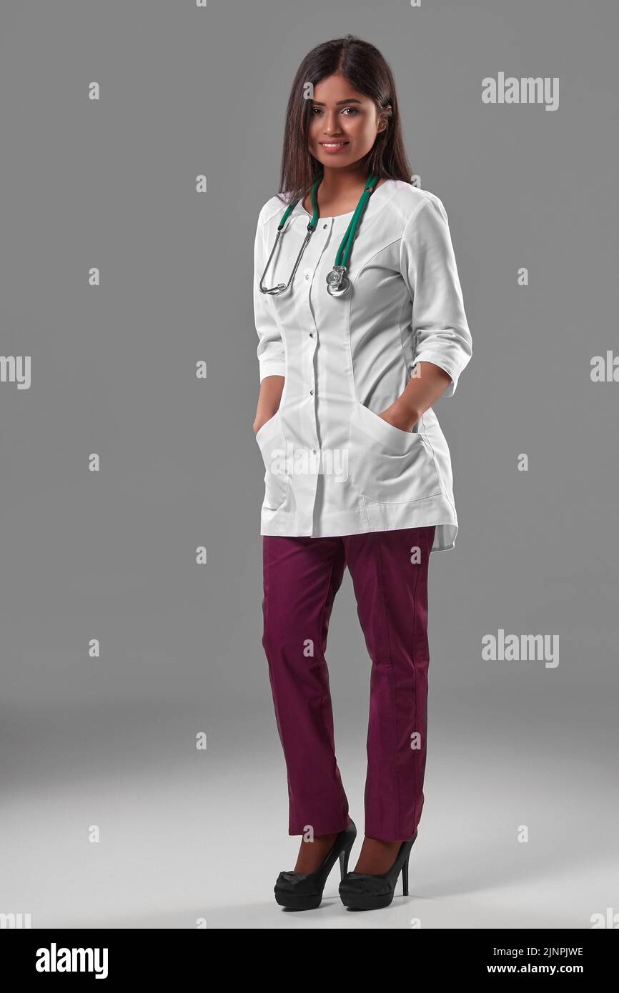 Beautiful young doctor in a medical robe with a stethoscope Stock Photo ...