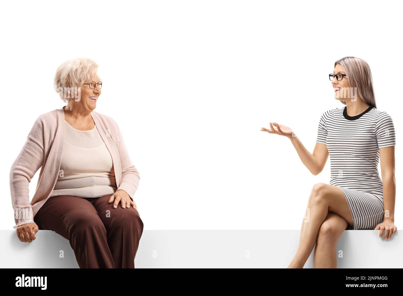 Pensioner and a young woman sitting on a panel and having a ...