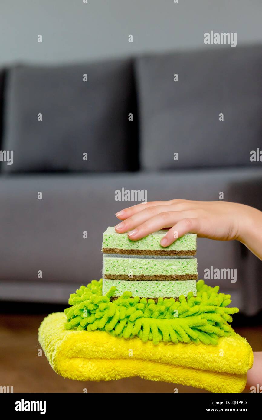 Colored rags and washcloths for manual cleaning on a woman's hand ...
