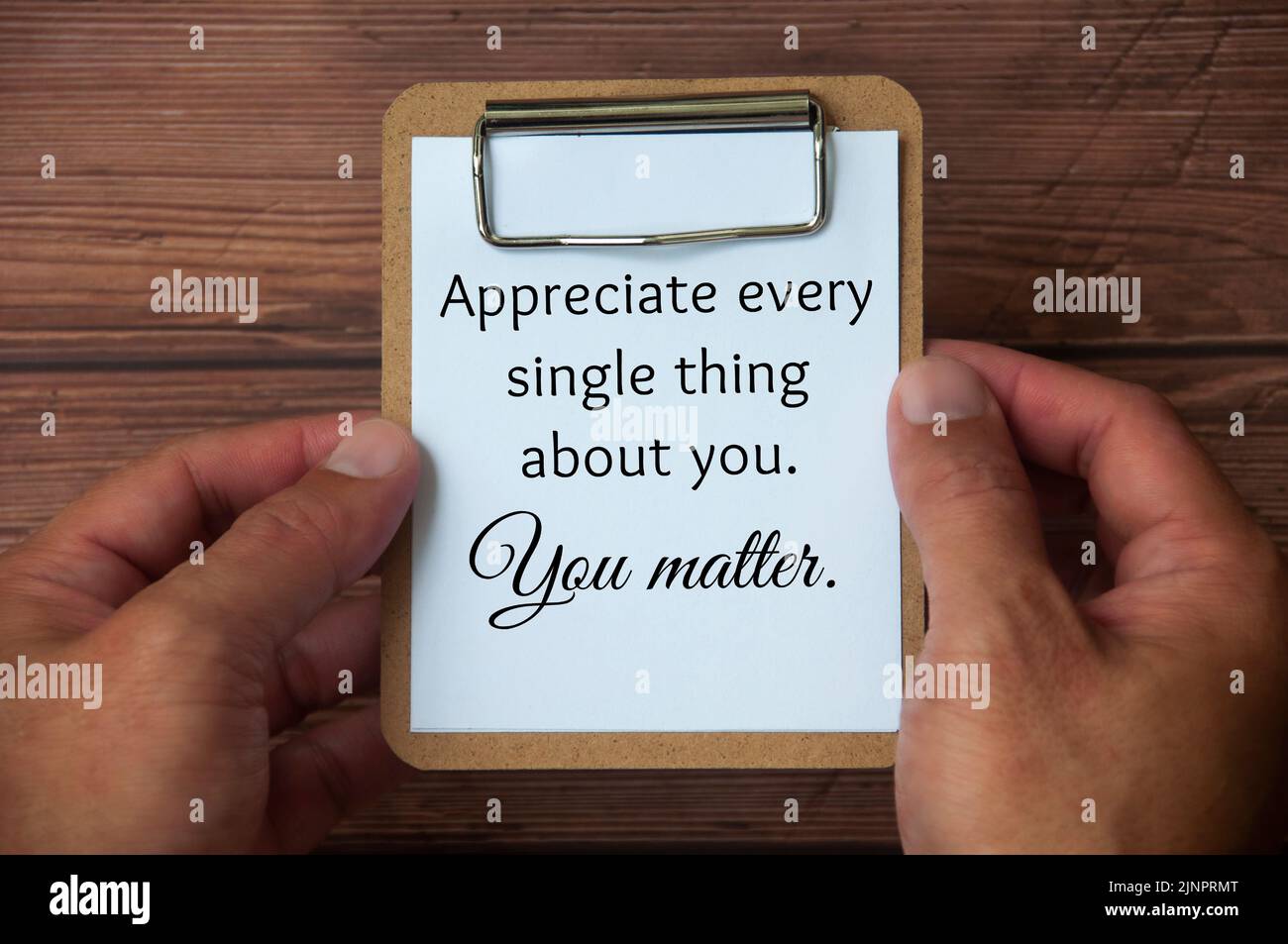 Hand holding paper holder board with text on white notepad - Appreciate ...