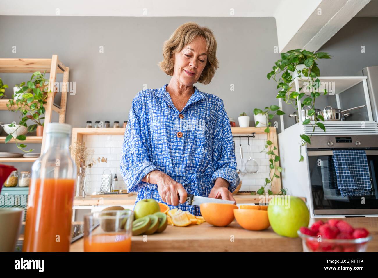 Beautiful mature senior woman at home, domestic life and leisure ...