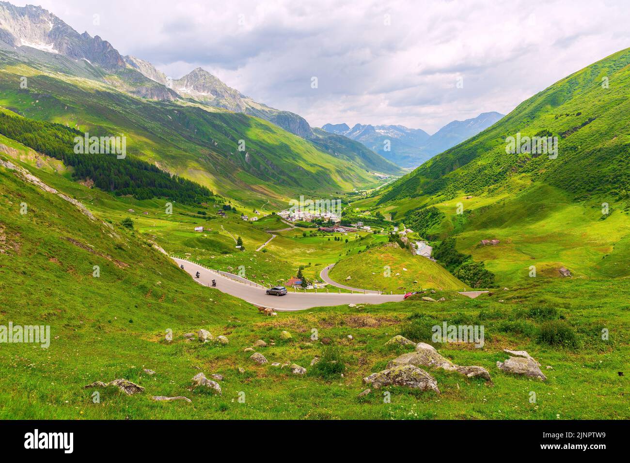 Swiss Alps, Furk pass. Motorcyclists and cars ride along the serpentine ...