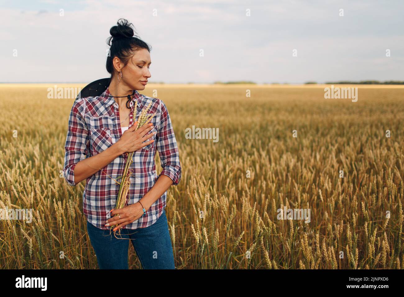 Woman american farmer with sheaf ears wearing cowboy hat, plaid shirt ...