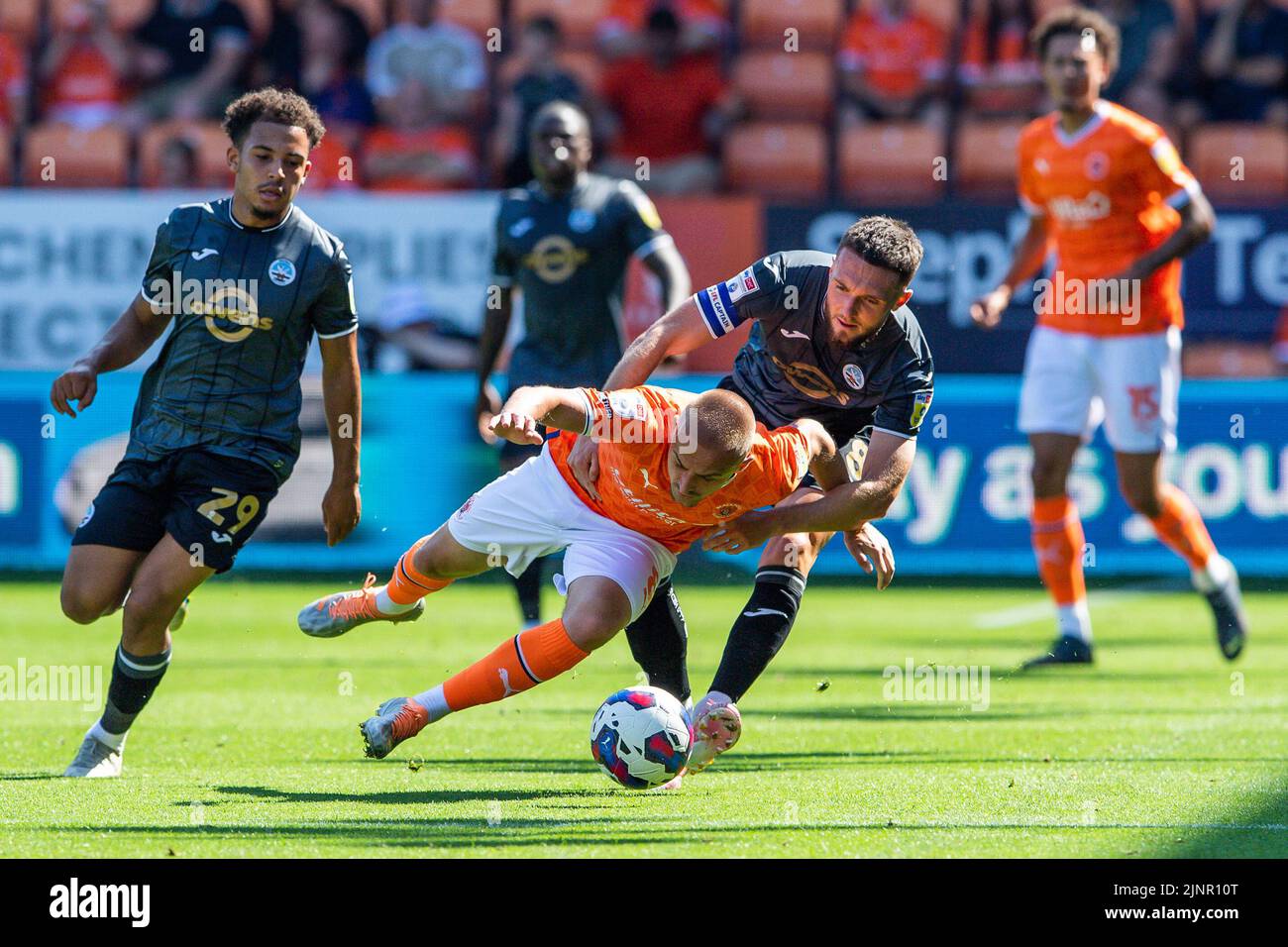 Lewis Fiorini #8 of Blackpool is fouled by Matt Grimes #8 of Swansea ...