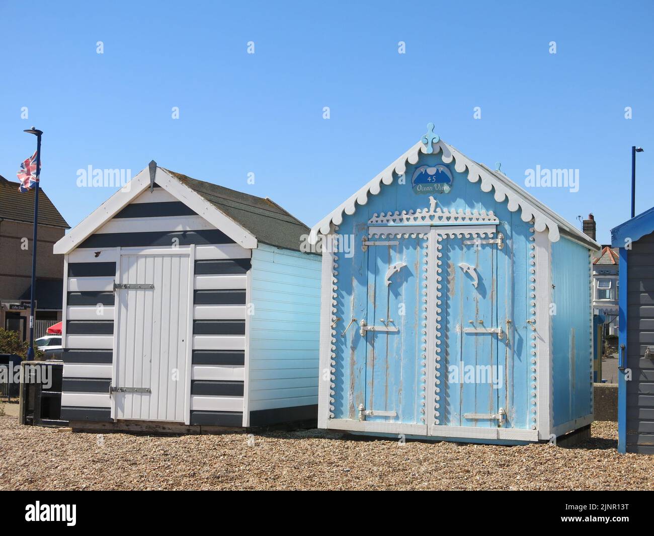 Two prettily decorated beach huts on the sands at Felixstowe, one of ...