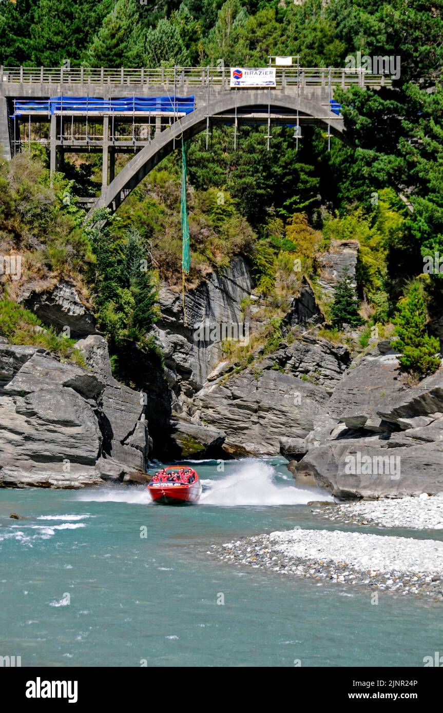 Visitors enjoy the high-speed thrills on a Shotover jet flat bottom ...