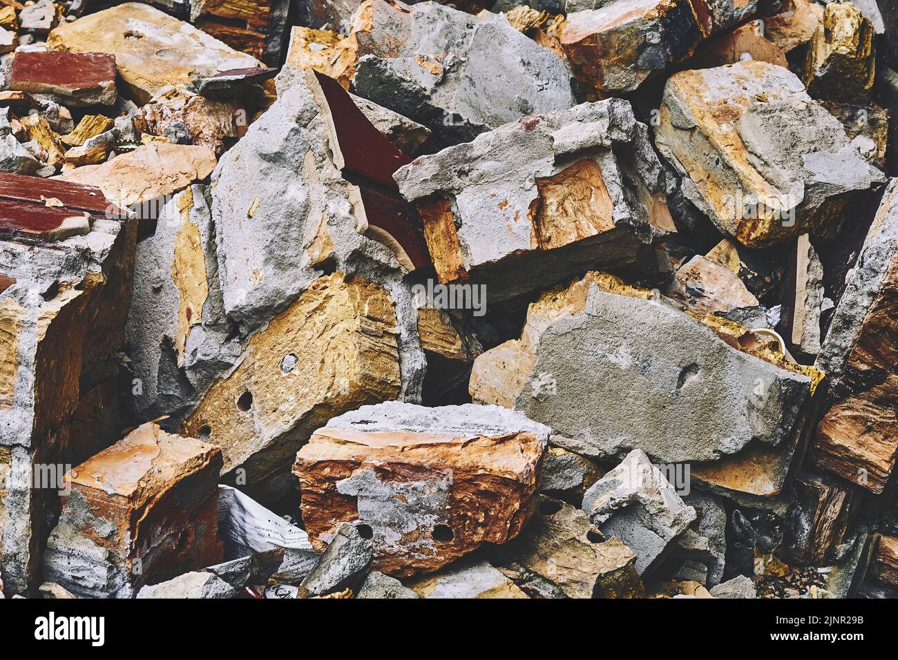 After the disaster. A pile of orange brick fragments left after the ...