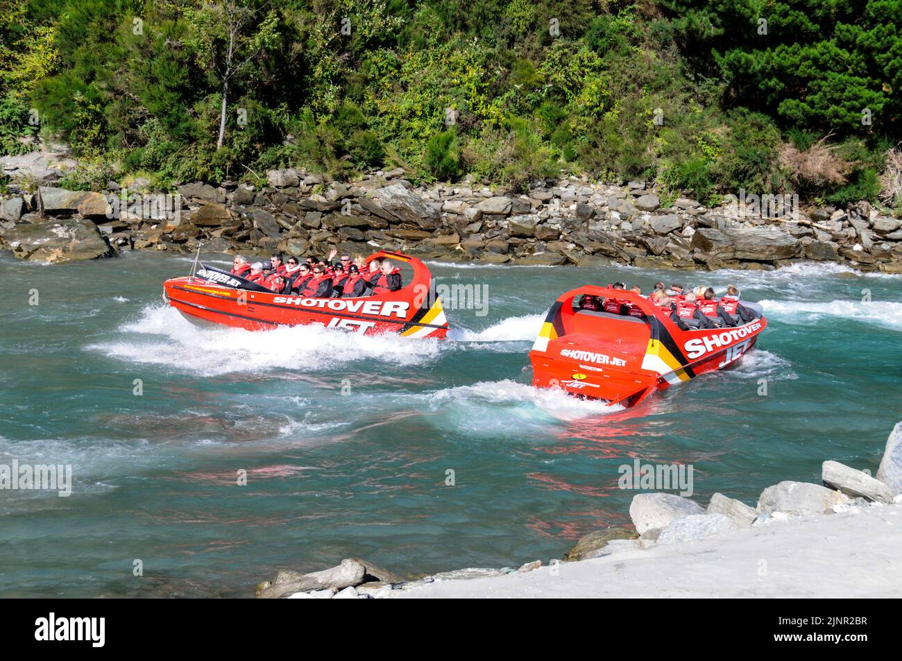 Visitors enjoy the high-speed thrills on a 'Shotover jet flat bottom ...